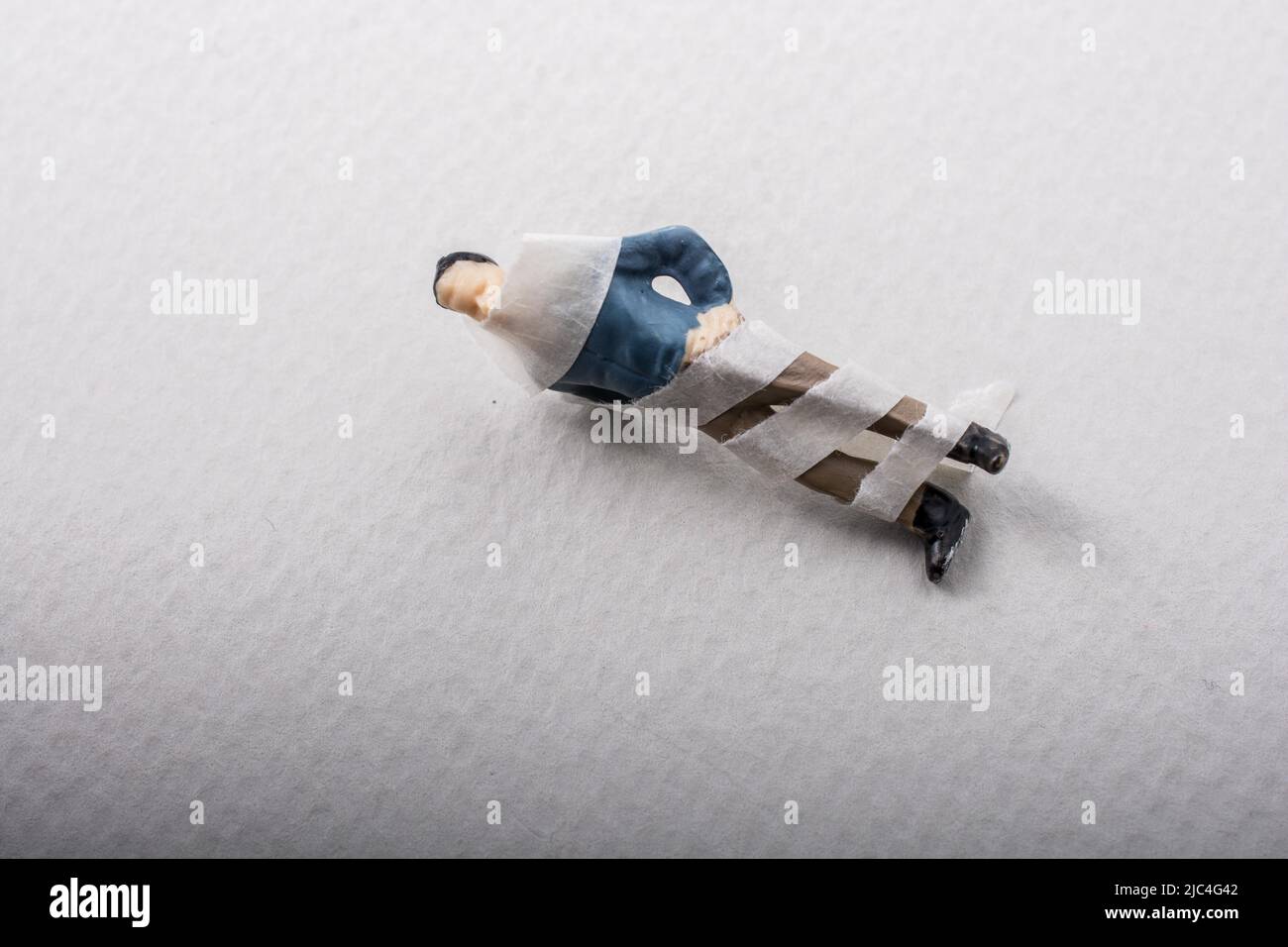 Tiny figurine of man miniature model wrapped in bandages Stock Photo ...