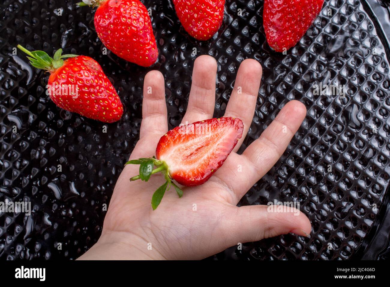 Juicy, sweet and ripe strawberry fruit in hand Stock Photo - Alamy