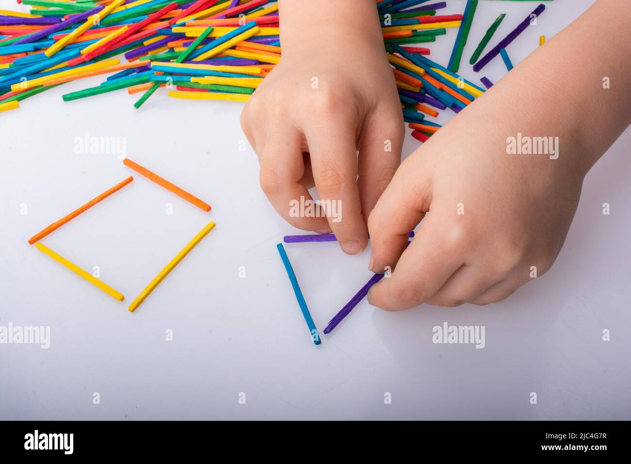 Kid making rectangular and triangle shape as creative concept Stock ...