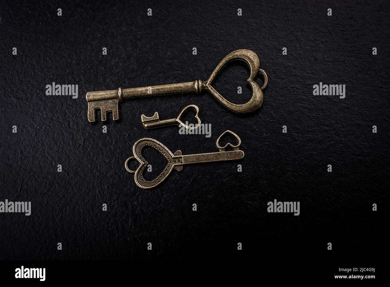 Heart shaped retro metal keys on dark background Stock Photo - Alamy