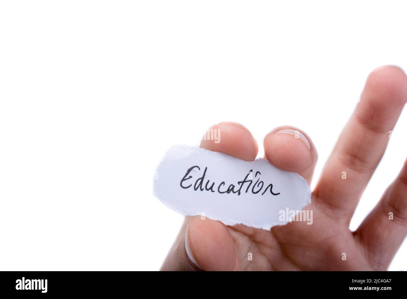 Child hand holding a education written a piece of torn paper Stock ...