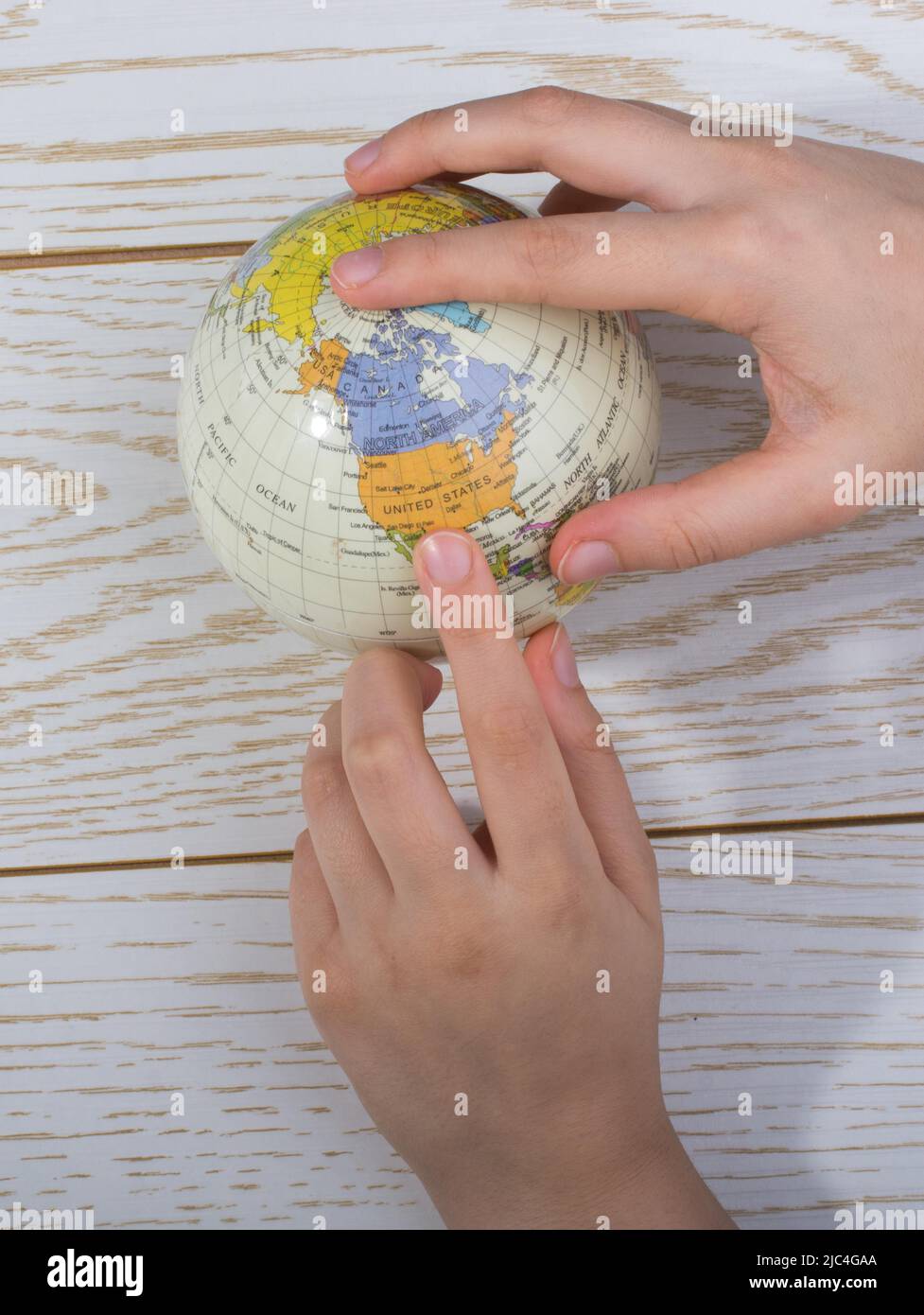 Hand holding a globe with map on it Stock Photo - Alamy