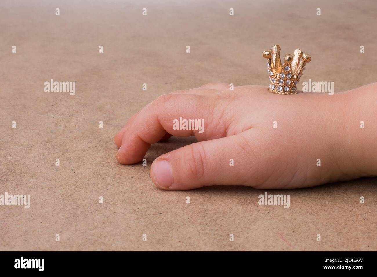 Model crown with pearls placed on a hand Stock Photo - Alamy