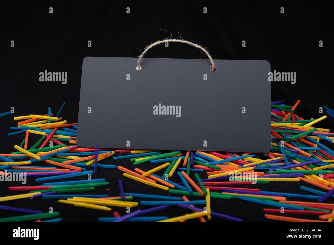 Rectangular shaped black notice board on colorful sticks on black Stock ...