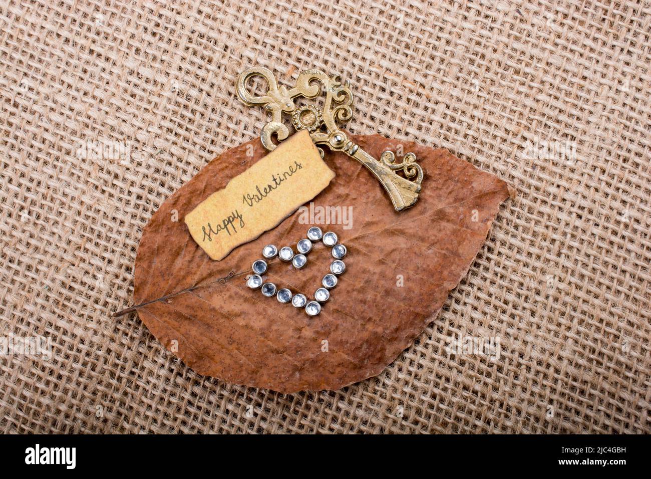 Love icon and Valentine's day wording on torn paper Stock Photo - Alamy