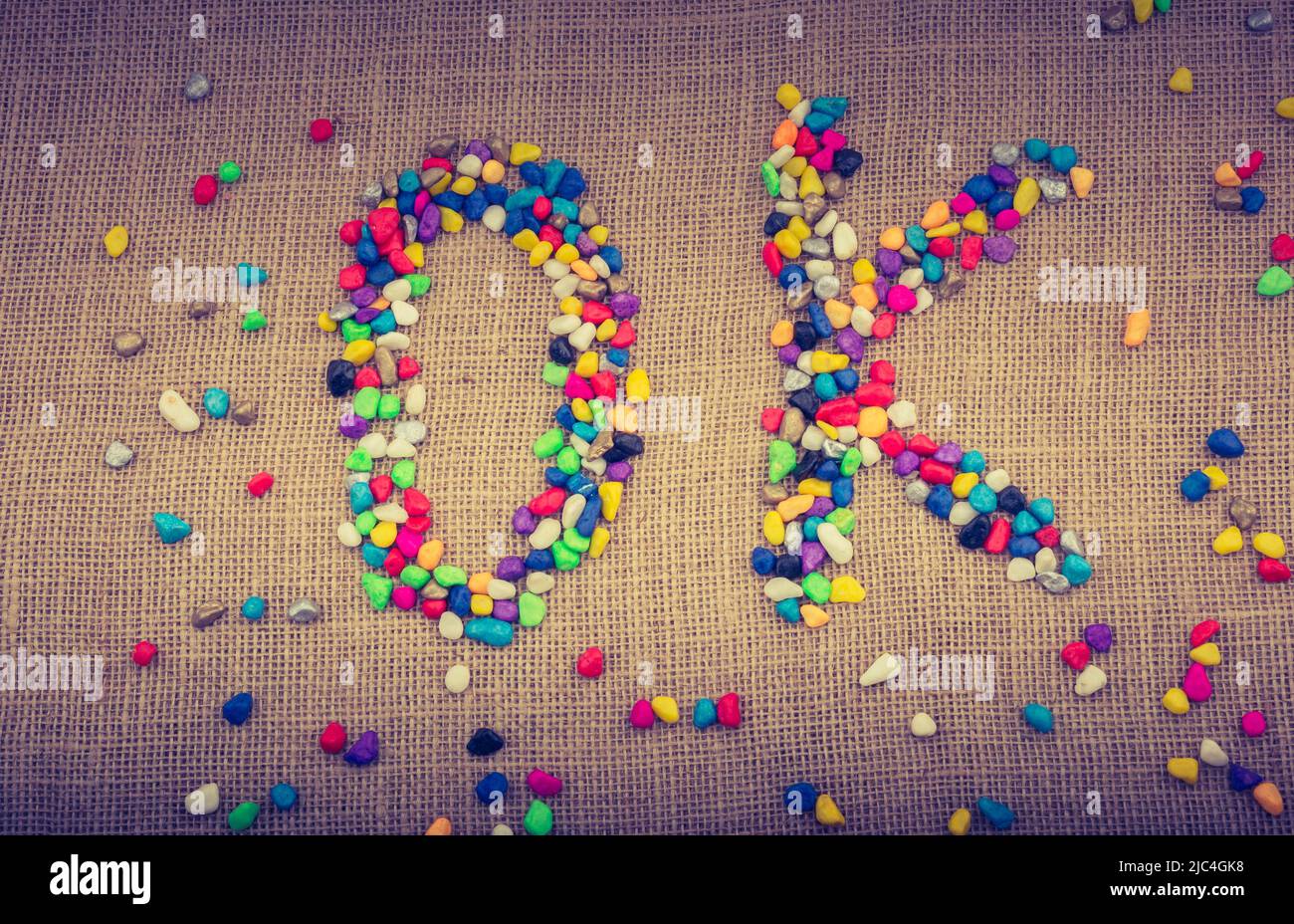 Colorful pebbles form the word OK on canvas ground Stock Photo - Alamy
