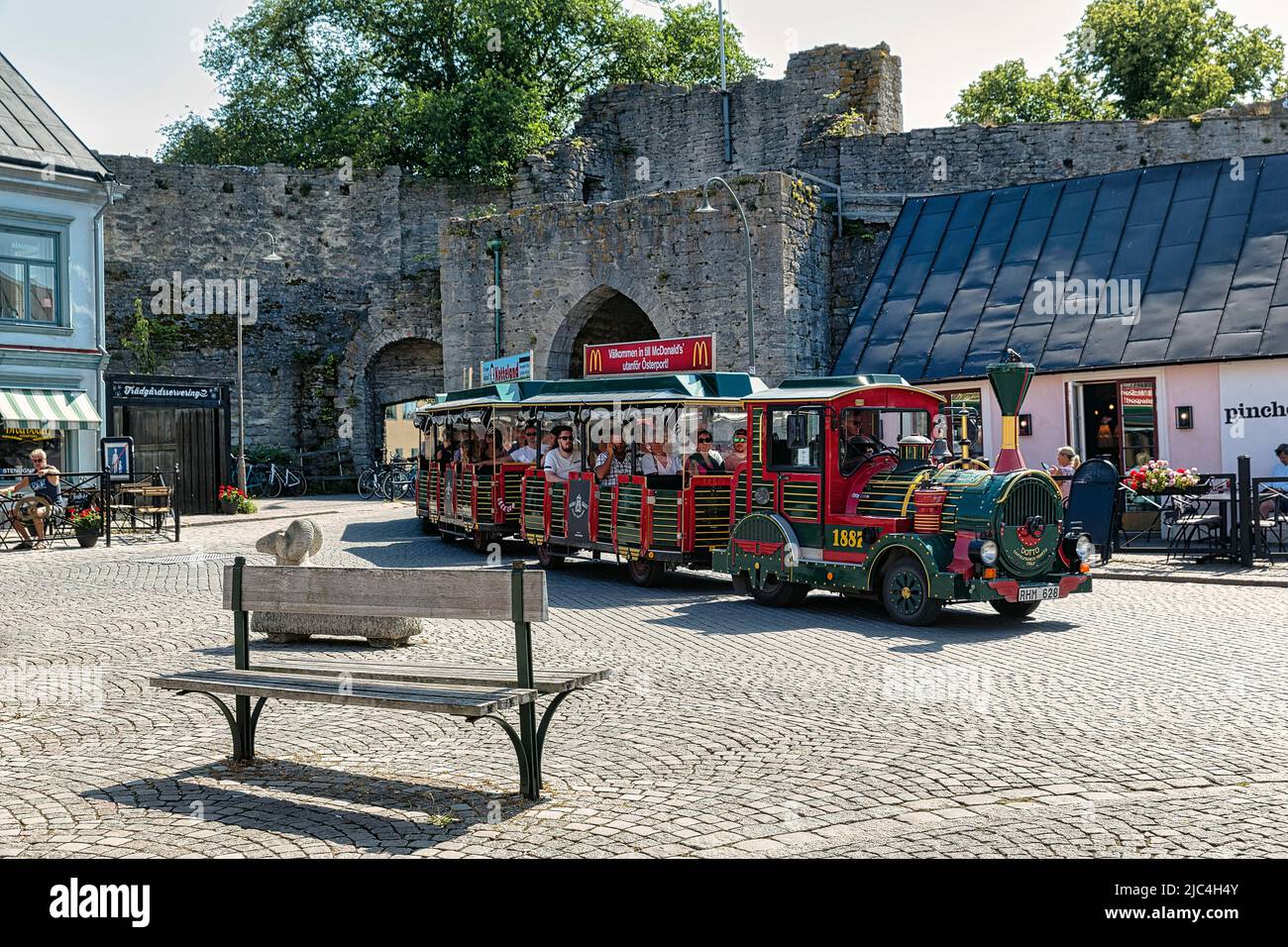 Tourist train in front of the city wall, city fortification, pedestrian ...
