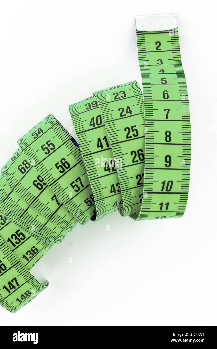 Green measuring tape of the tailor on white background Stock Photo - Alamy