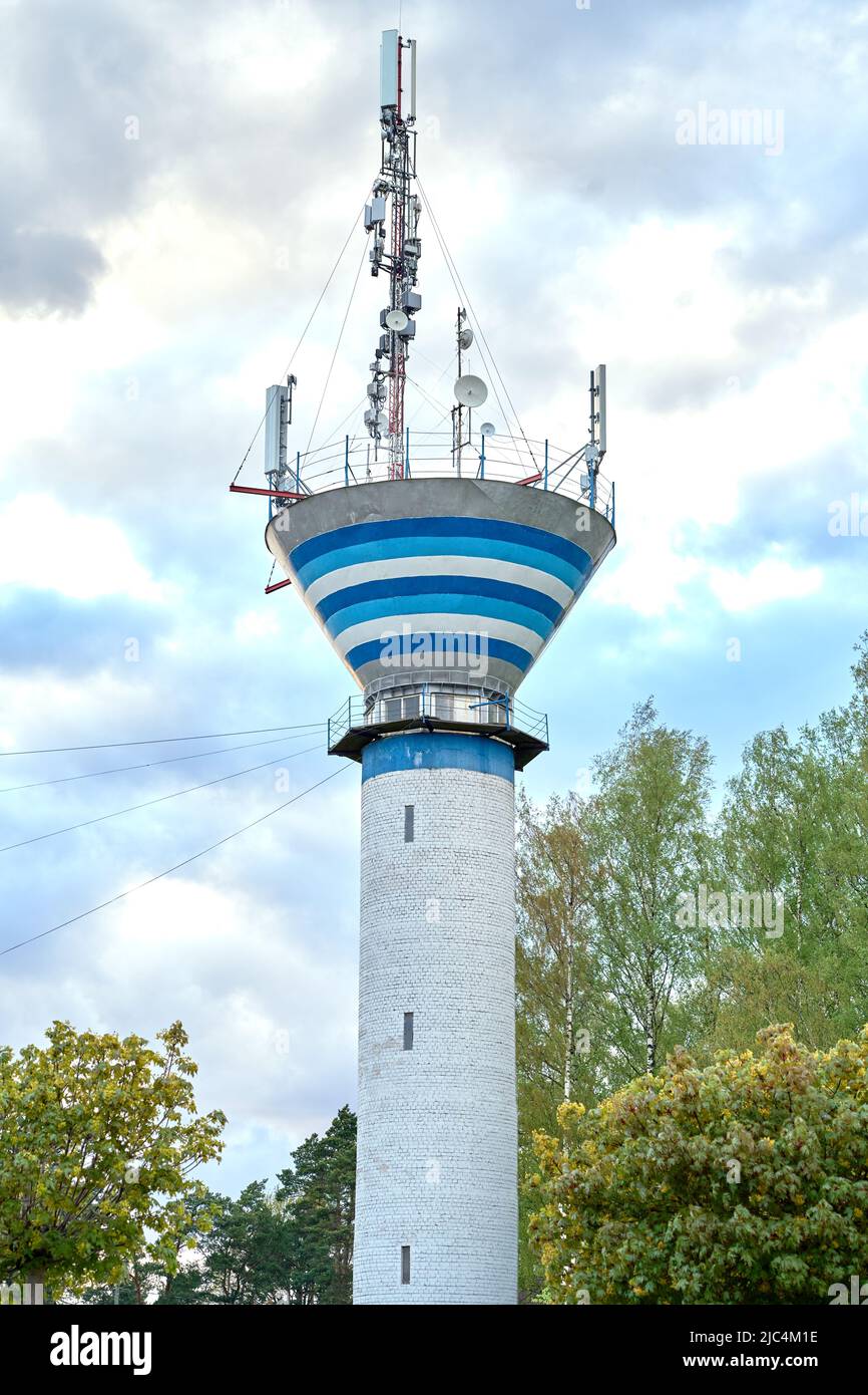 White brick water tower with wireless communication antenna transmitter ...