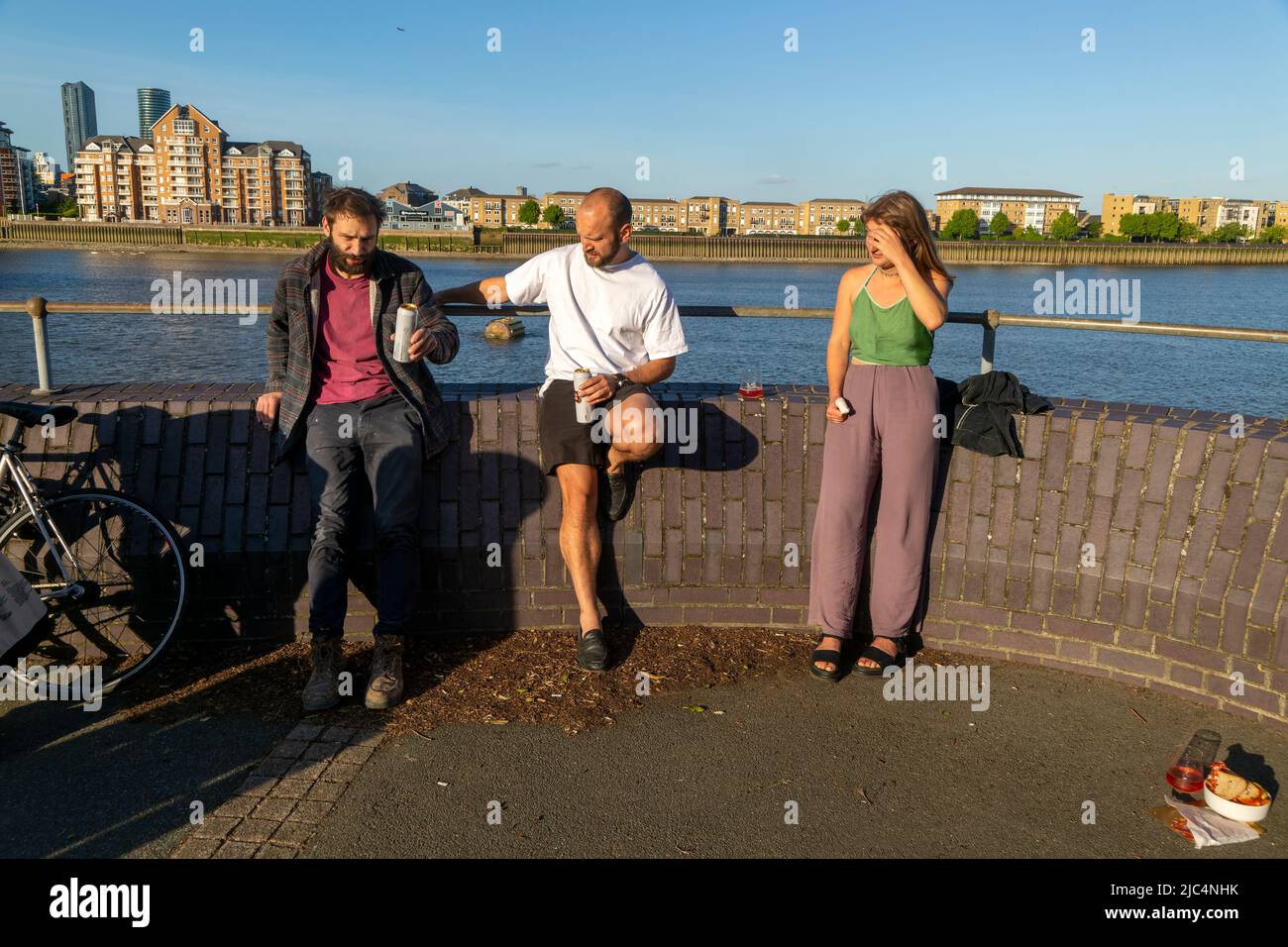 Young people enjoying outdoor Friday evening afterwork drinks by the ...