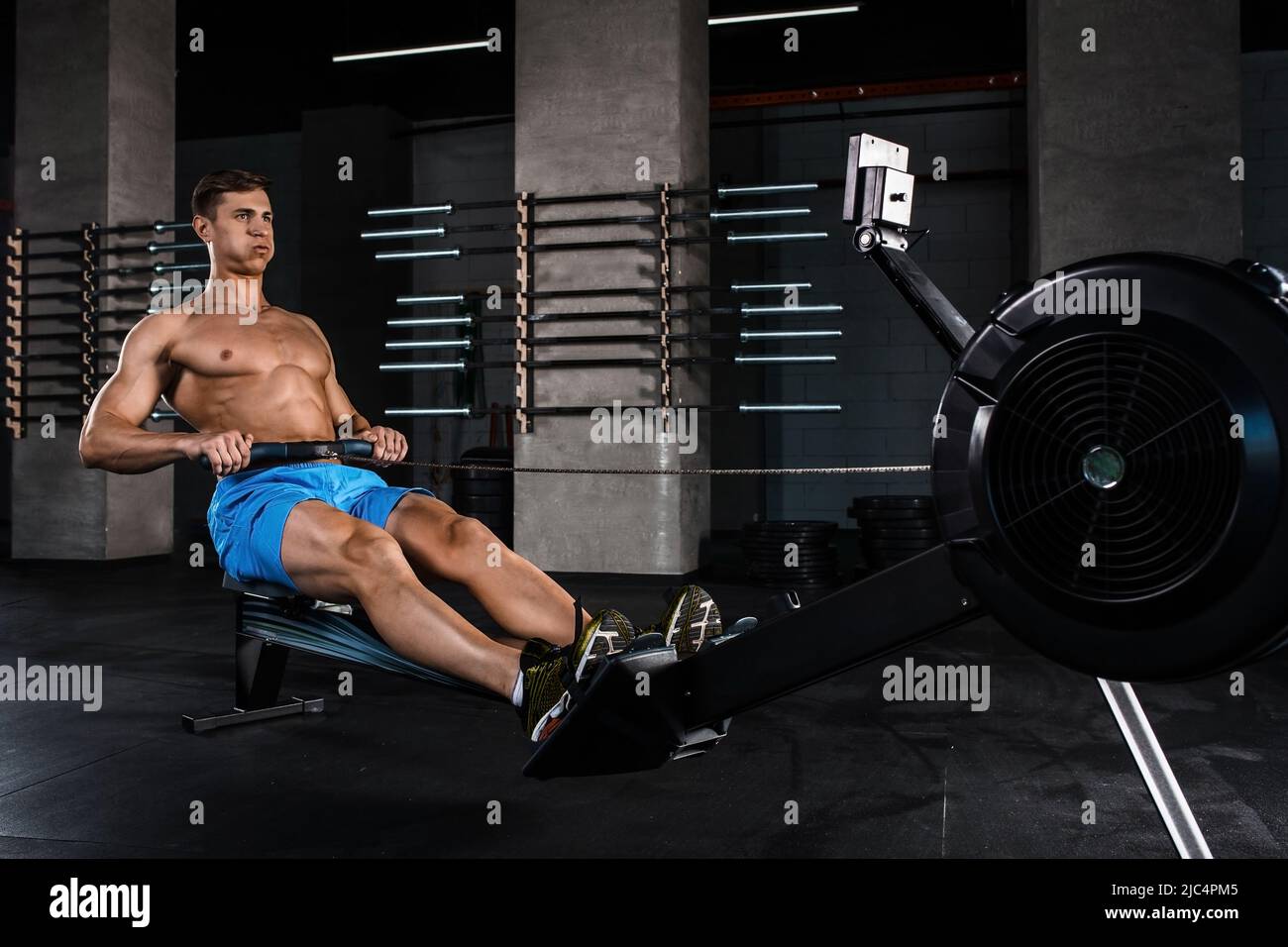 Bodybuilder working on his legs with weight machine at the gym Stock ...