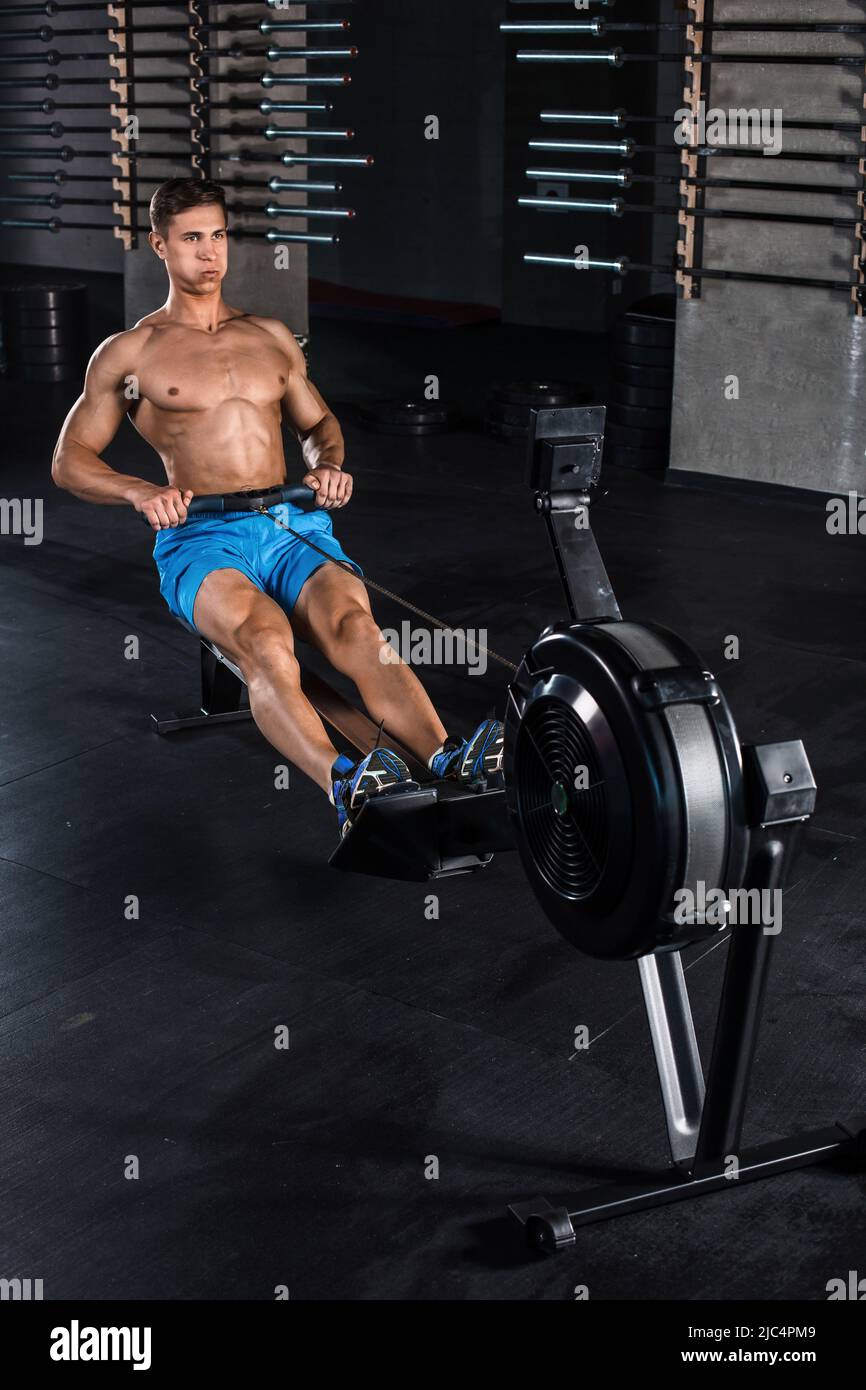 Bodybuilder working on his legs with weight machine at the gym Stock ...