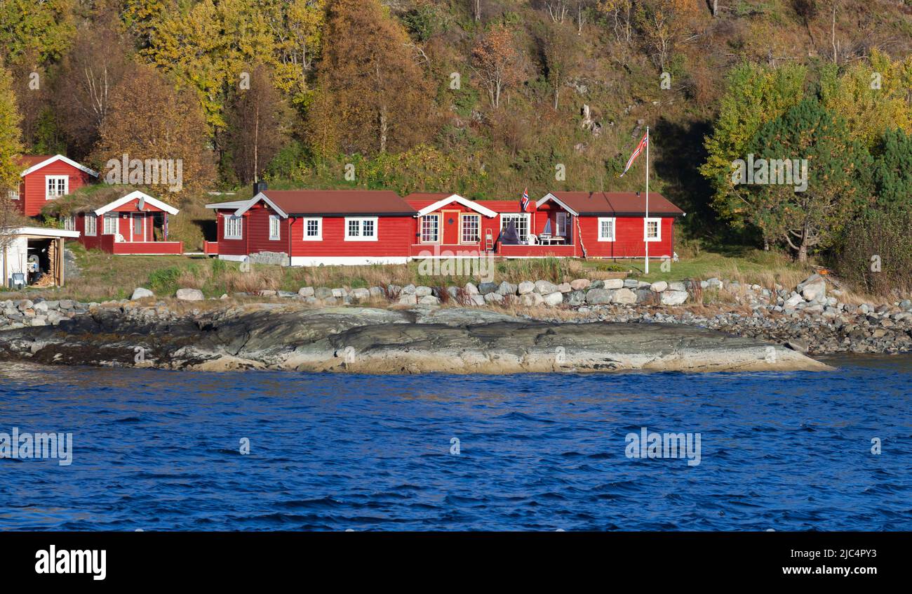 Norwegian coastal landscape with traditional red wooden houses and ...