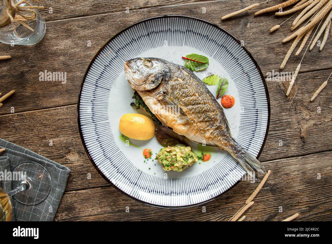 Top view on plate of grilled gourmet fish Stock Photo - Alamy