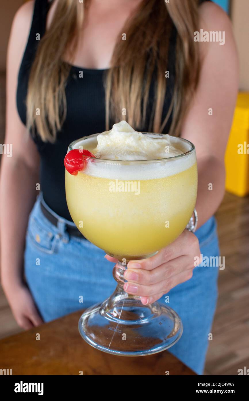 A girl showing a delicious pinapple drink shake Stock Photo - Alamy