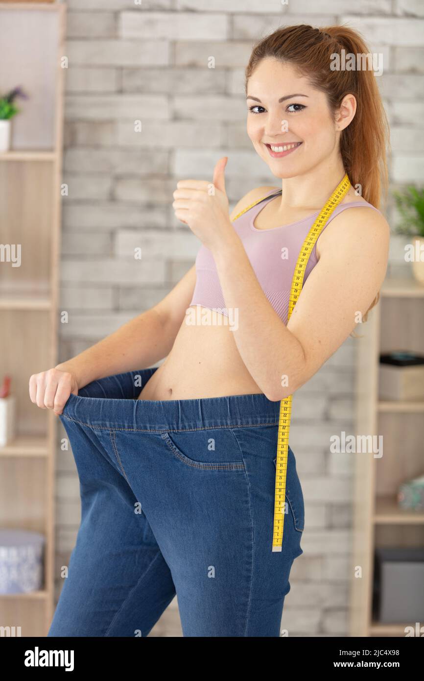 weight loss woman wearing her old jeans and measure tape Stock Photo ...