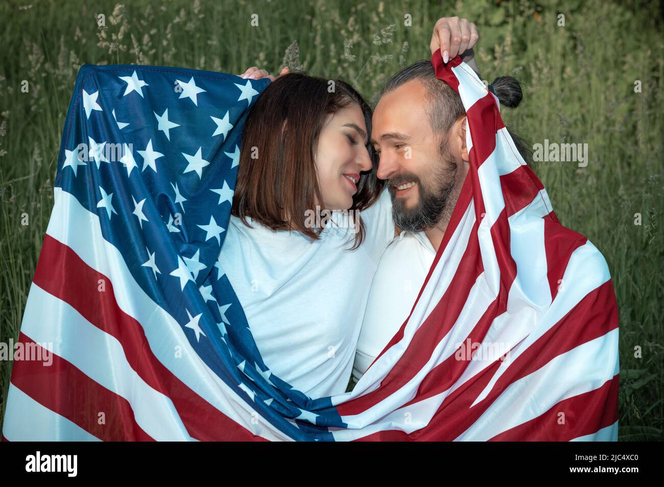 Loving couple celebrating USA Independence Day. Couple in love kissing ...