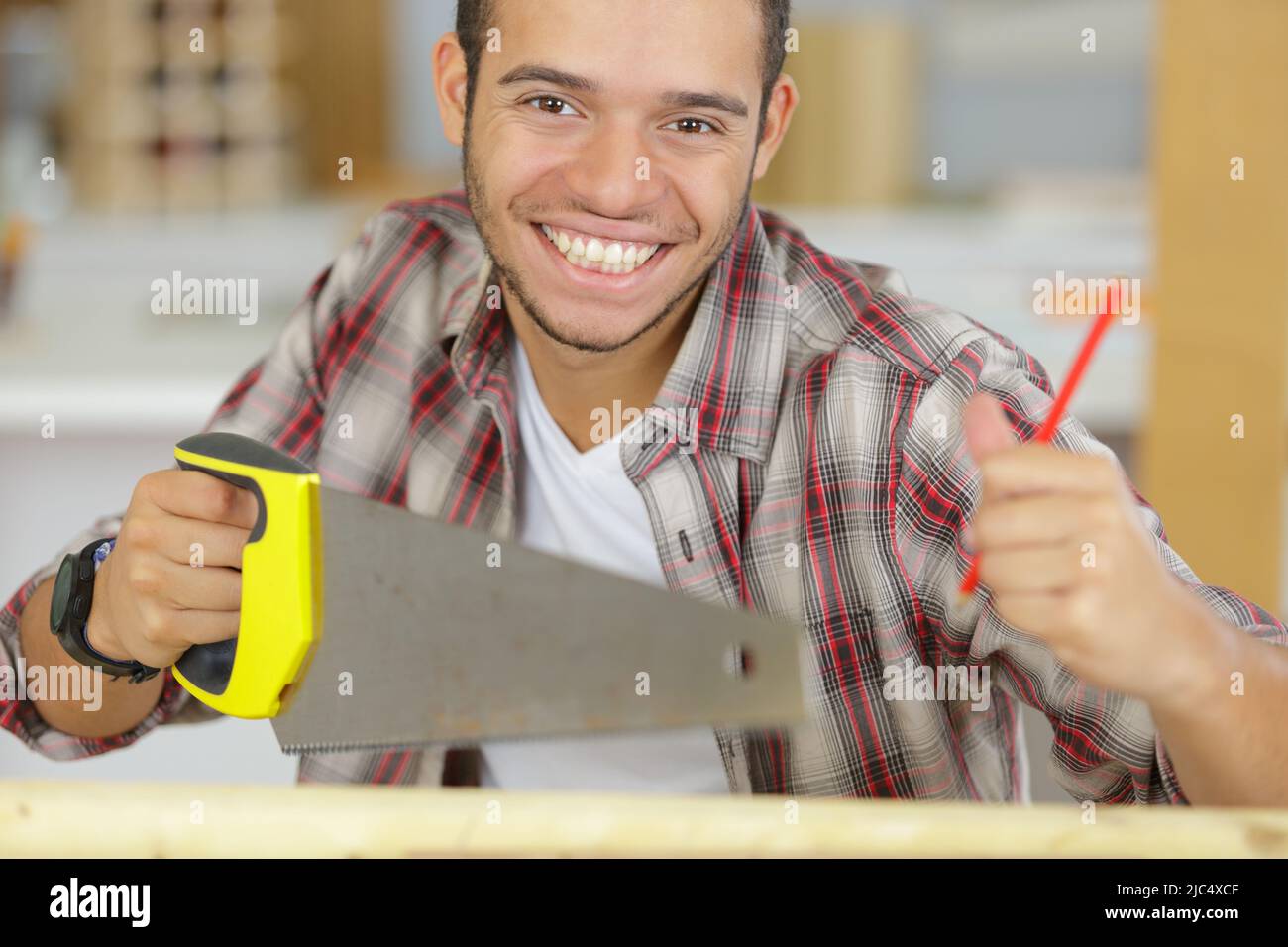 man repairman with hand saw Stock Photo - Alamy