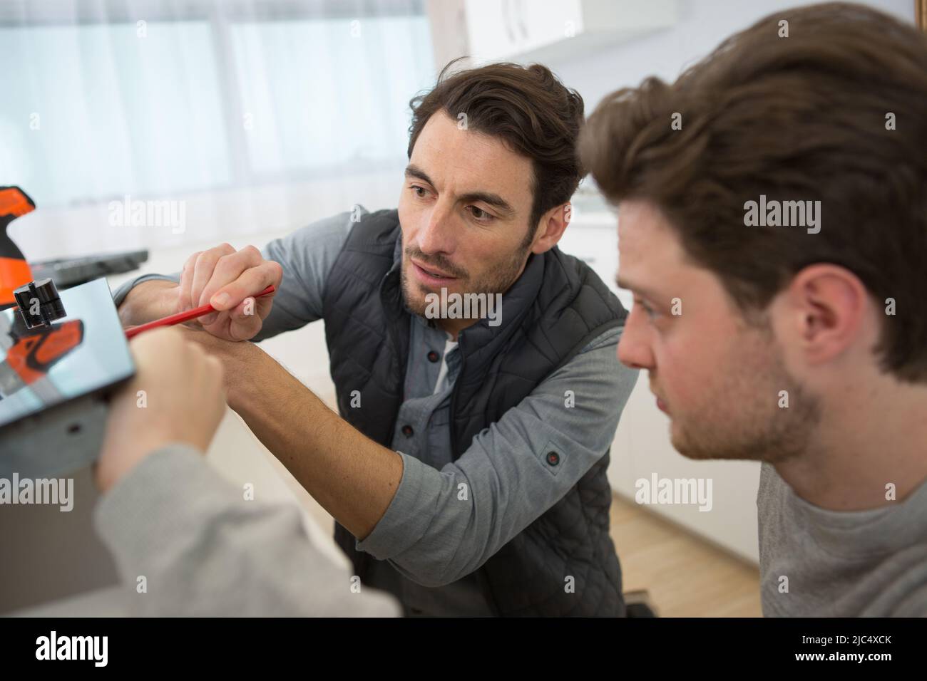 teacher and apprentice working together Stock Photo - Alamy
