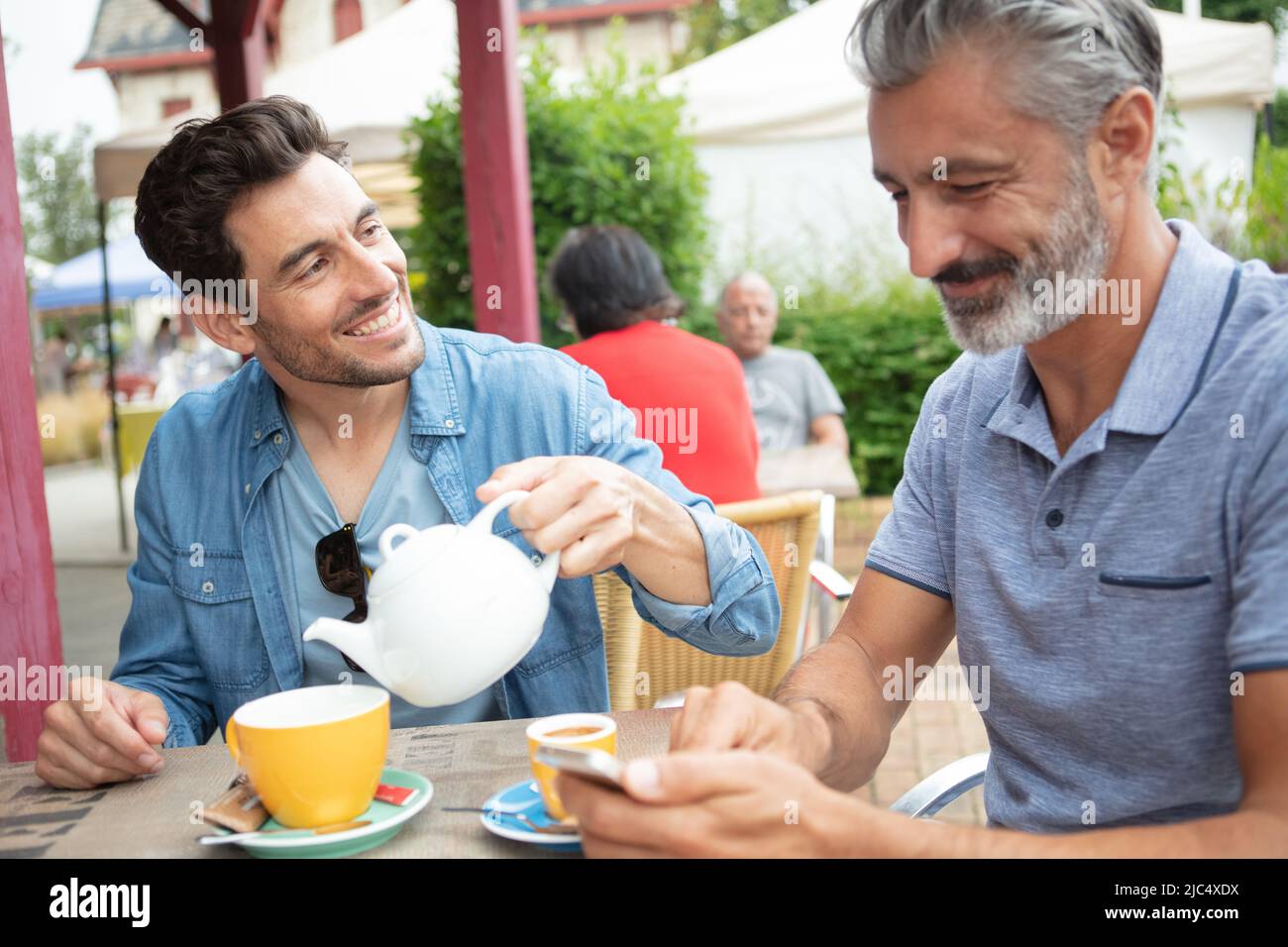 2 men drinking tea outdoors Stock Photo - Alamy