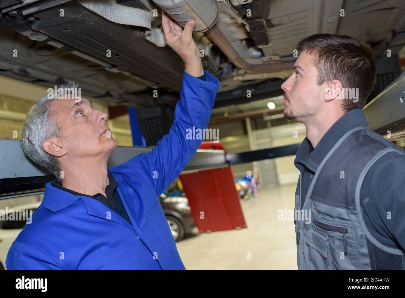 student with instructor repairing a car during apprenticeship Stock ...