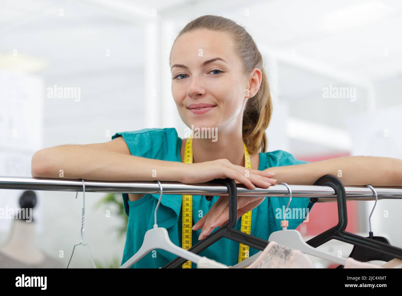 tailor posing on the clothing rack Stock Photo - Alamy