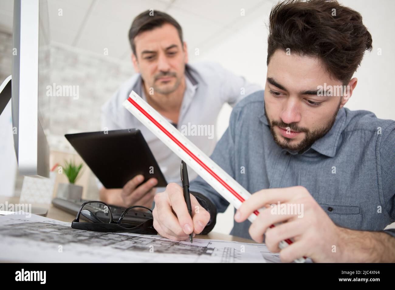 apprentice architect using a scale ruler Stock Photo - Alamy