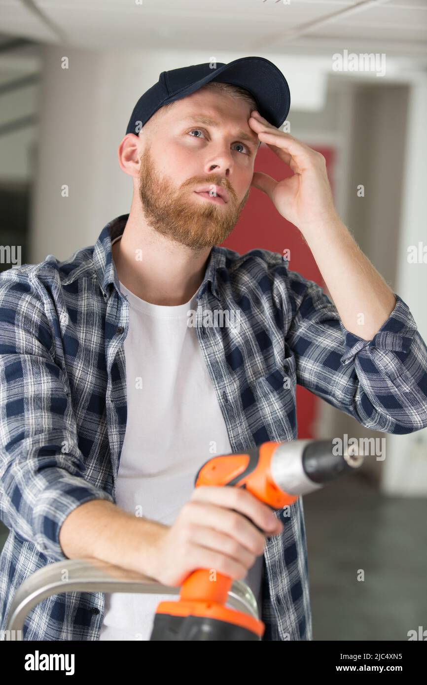 portrait of confused technician holding screwdriver Stock Photo - Alamy