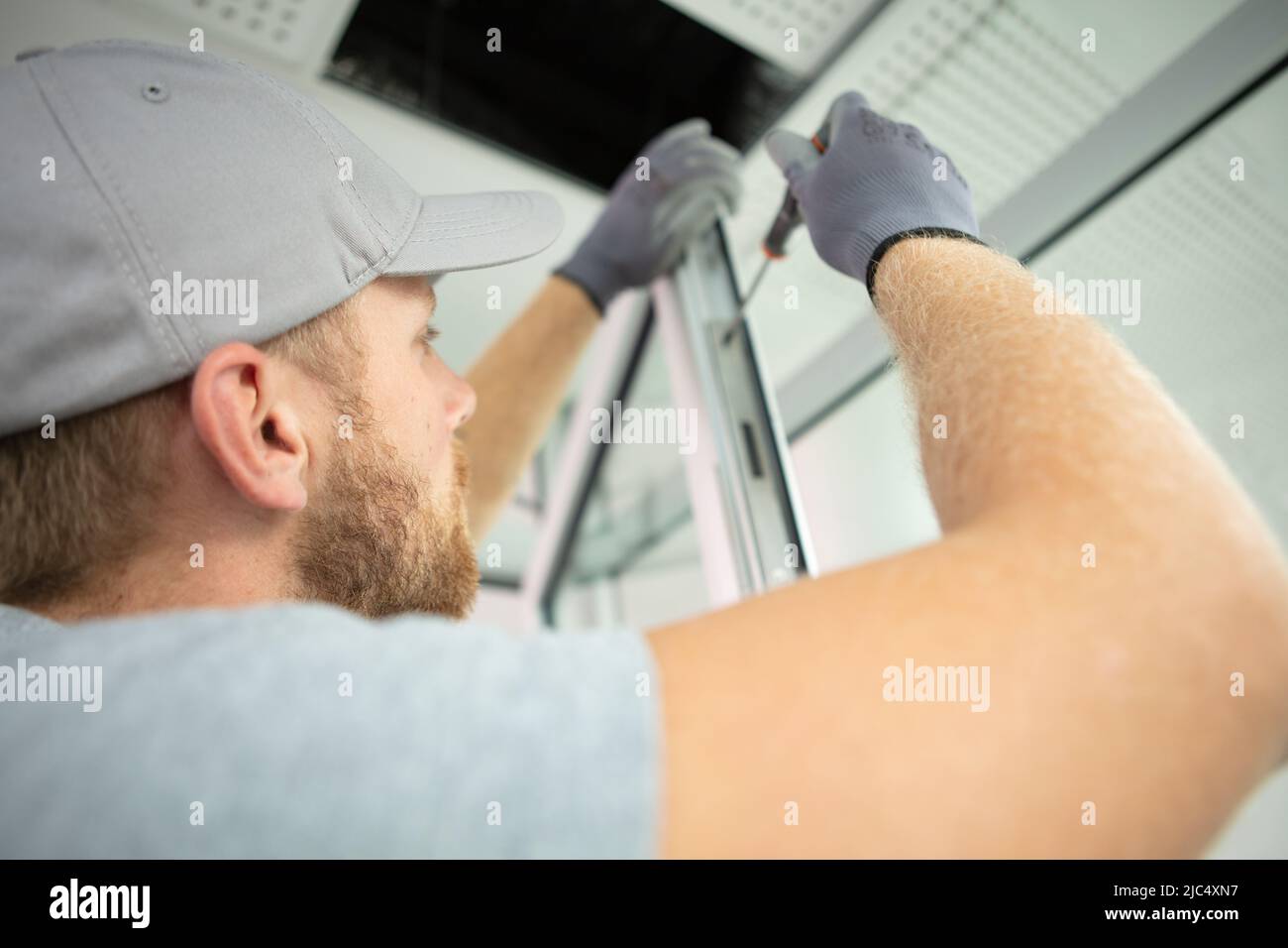 construction worker installing window in house Stock Photo - Alamy