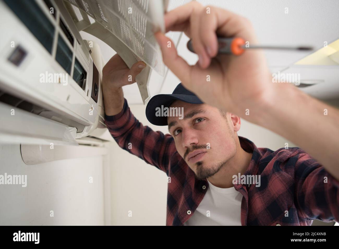 fixing and maintaining air conditioning system Stock Photo - Alamy