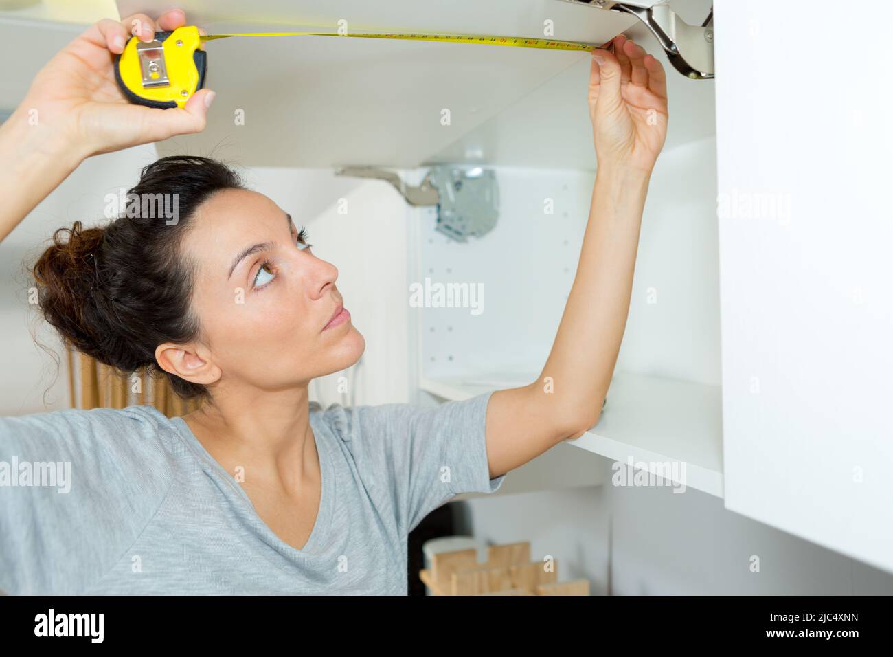 female measuring drawer with measure tape Stock Photo - Alamy