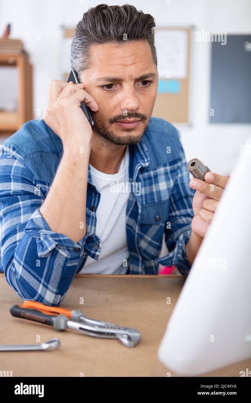 carpenter man using smart phone at workshop Stock Photo - Alamy