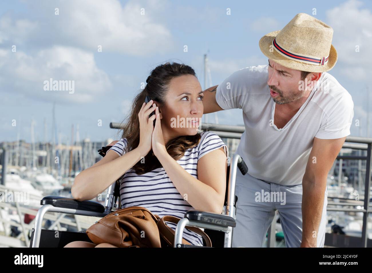 disabled woman talking on smartphone conferring with partner Stock ...