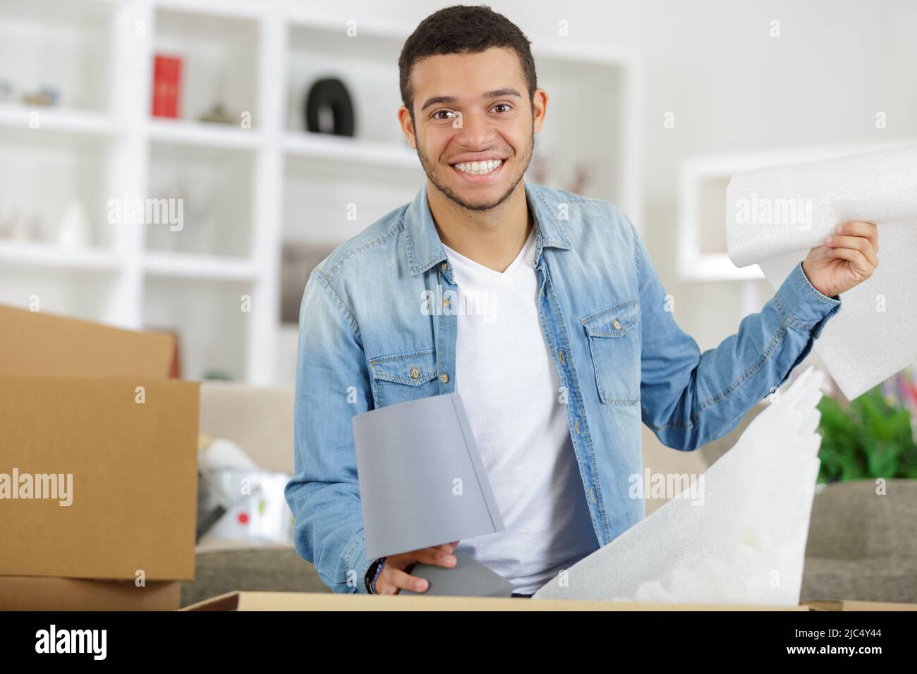 a young man packing box Stock Photo - Alamy