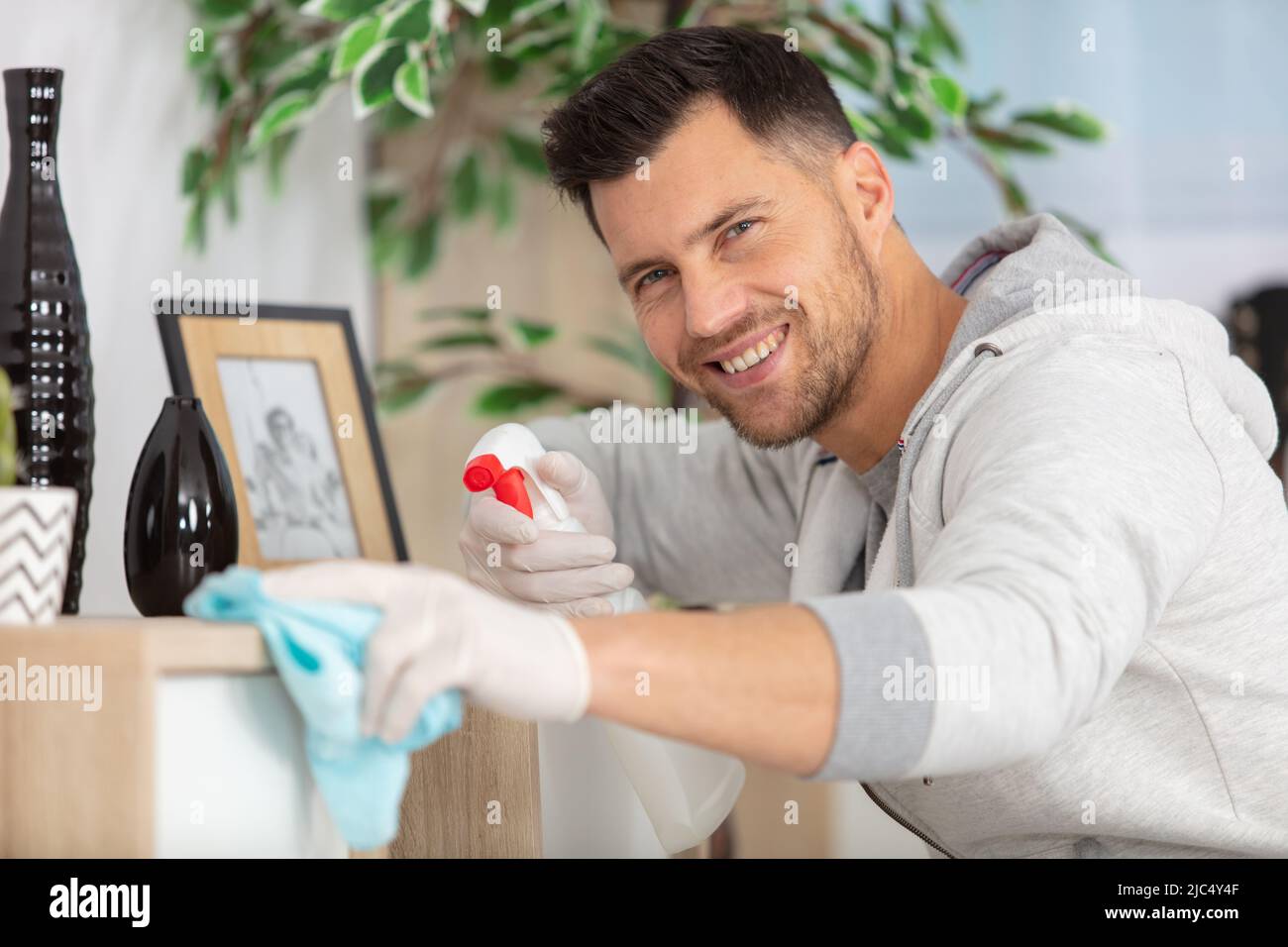 handsome concentrated man cleaning his flat Stock Photo - Alamy
