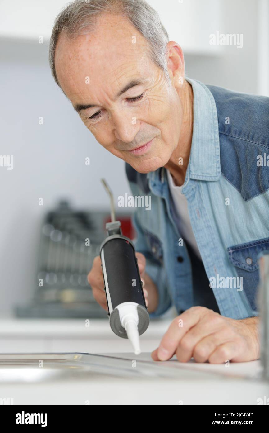Handyman using caulking gun caulk hi-res stock photography and images - Alamy