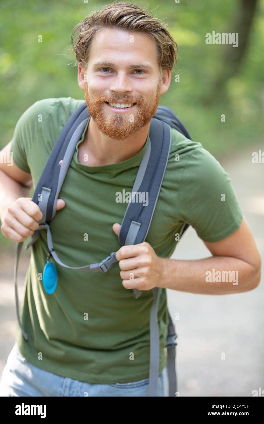 portrait of a young smiling wanderer man with backpack Stock Photo - Alamy