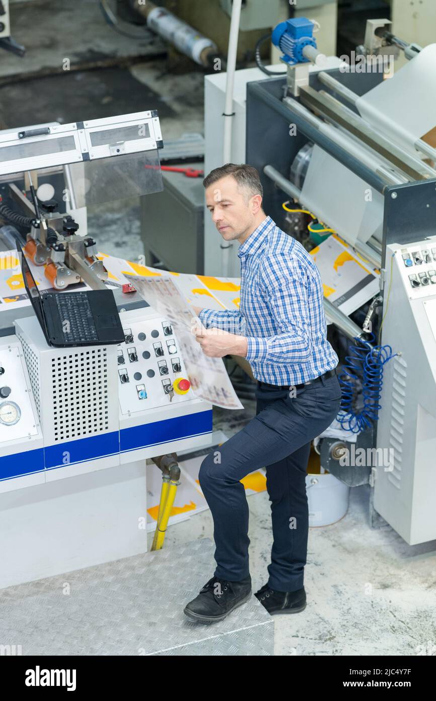 man in a printing factory Stock Photo - Alamy