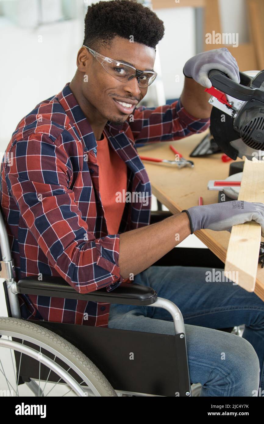 disabled worker in wheelchair in a carpenters workshop Stock Photo - Alamy