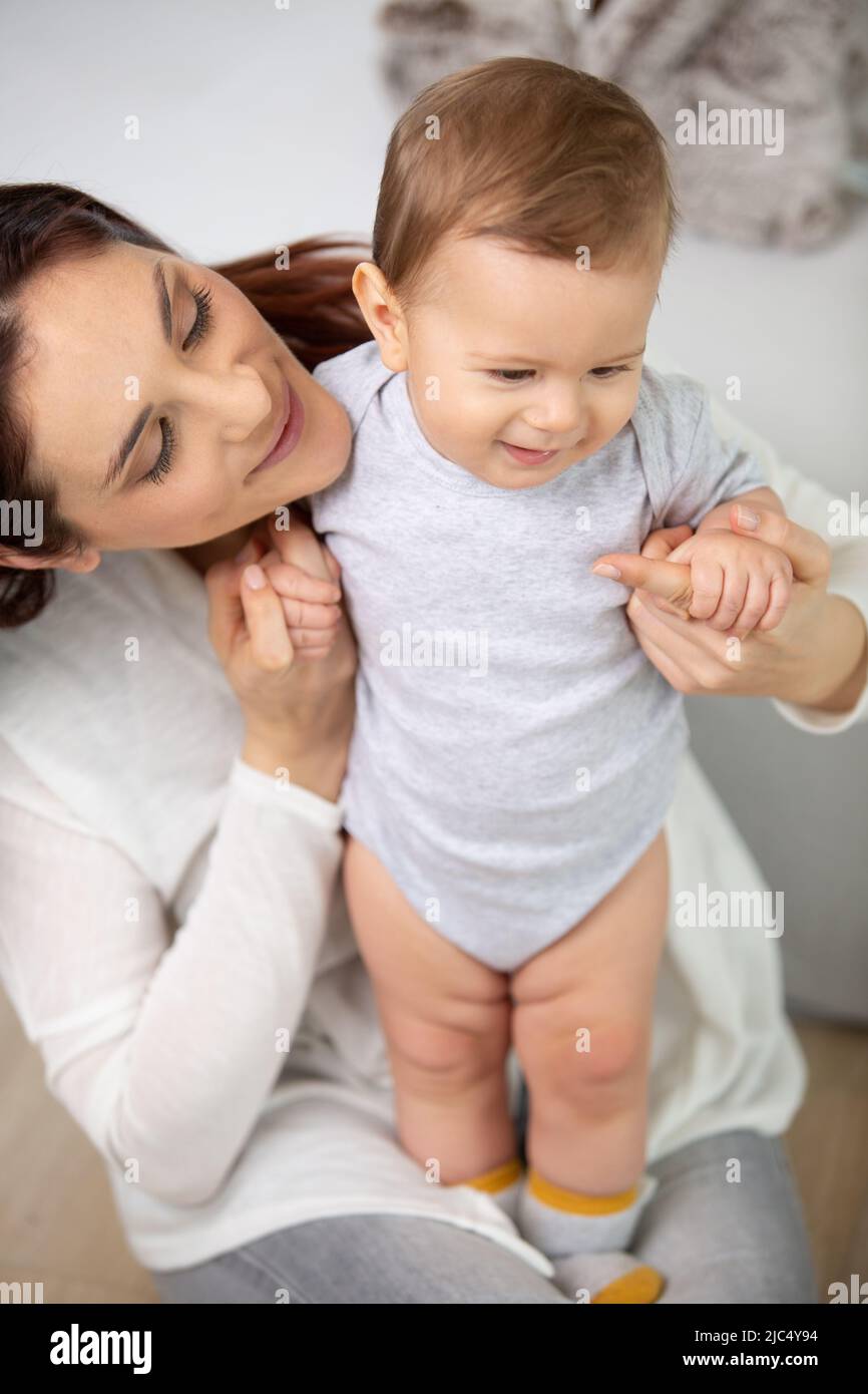mother standing holds the child in her arms Stock Photo - Alamy