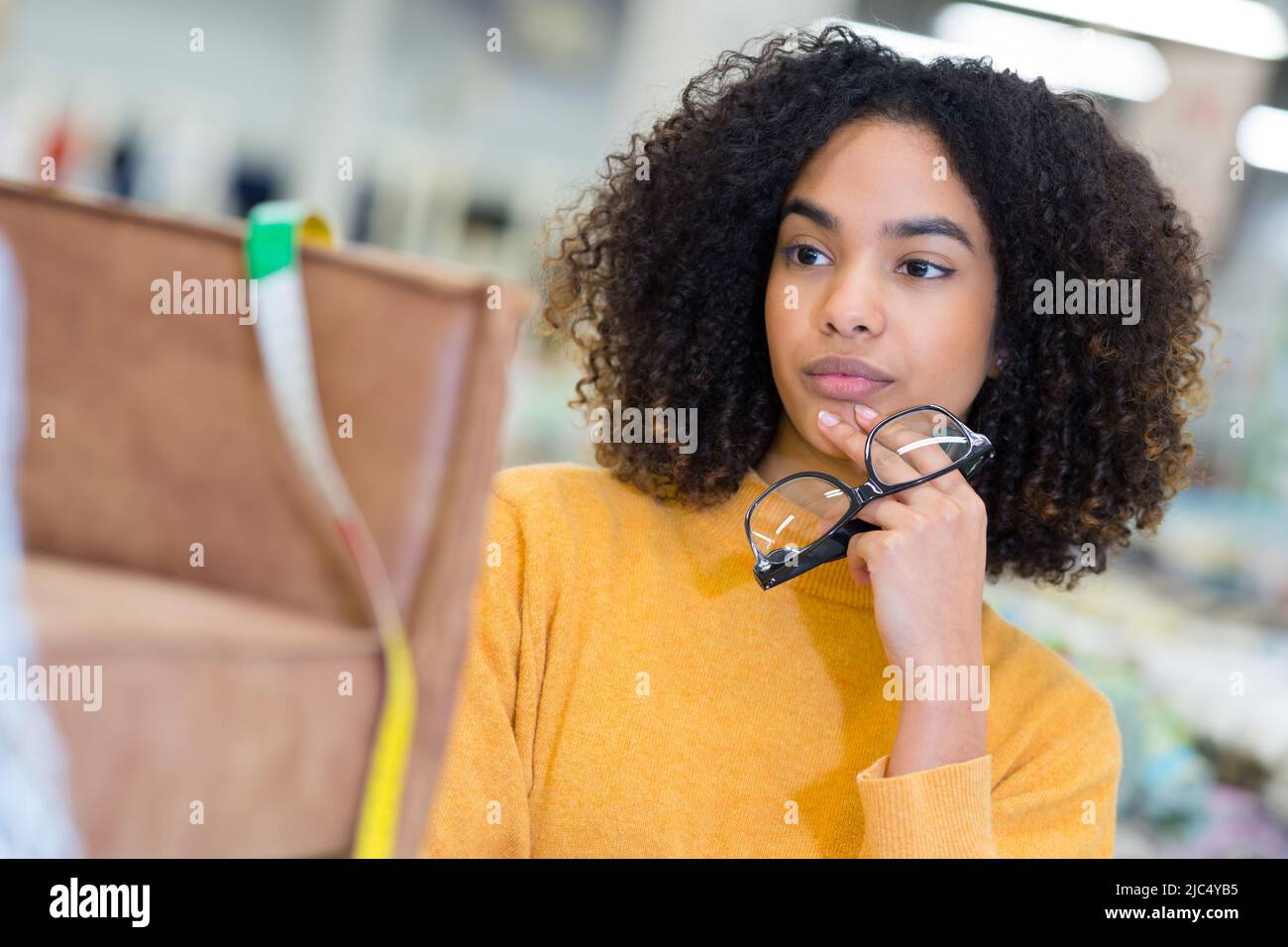 female upholsterer contemplating her job Stock Photo - Alamy