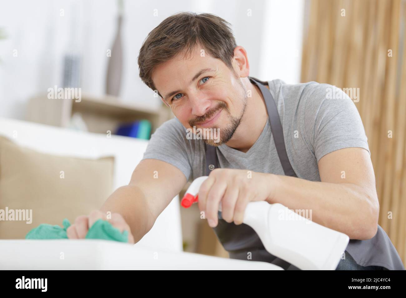 Cleaner spraying dry cleaning hi-res stock photography and images - Alamy