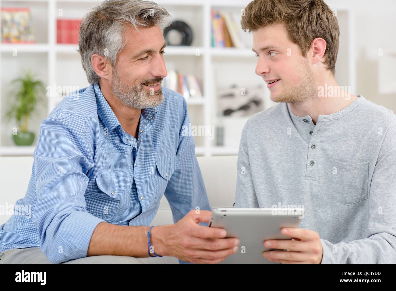 father and son using a tablet Stock Photo - Alamy