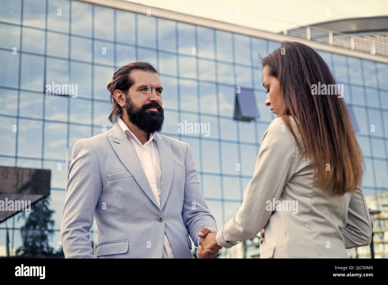 business couple shaking hands. bearded man meet woman outdoor. business ...