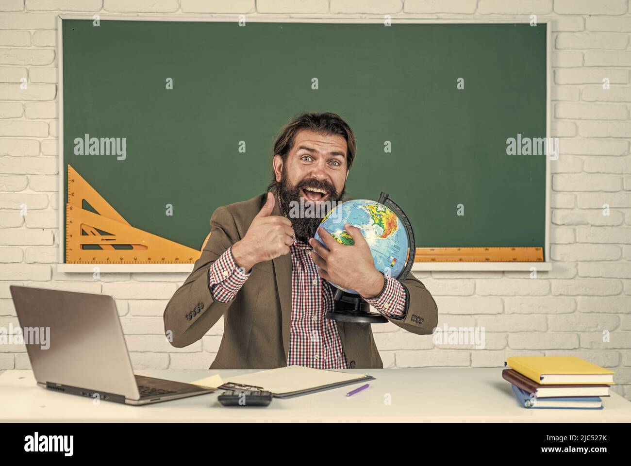 back to school. informal education. happy mature teacher hold globe and ...