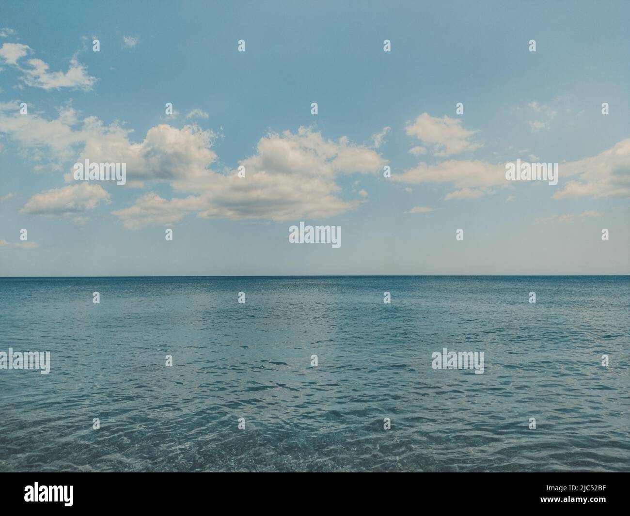 Calm Ocean Horizon with clouds Stock Photo - Alamy