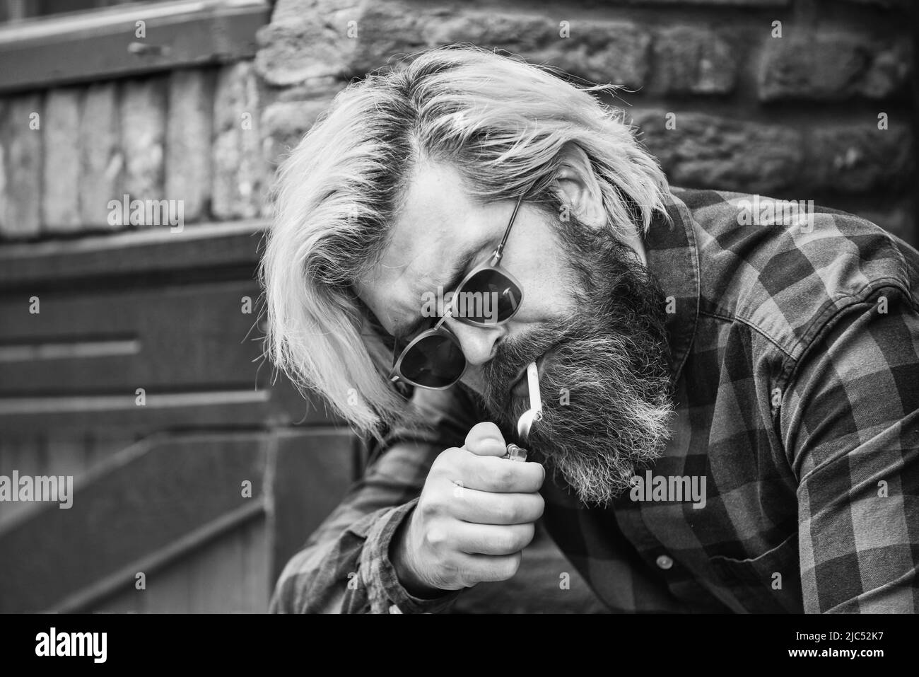 Need to quit smoking. he is heavy smoker. bearded man in glasses relax ...