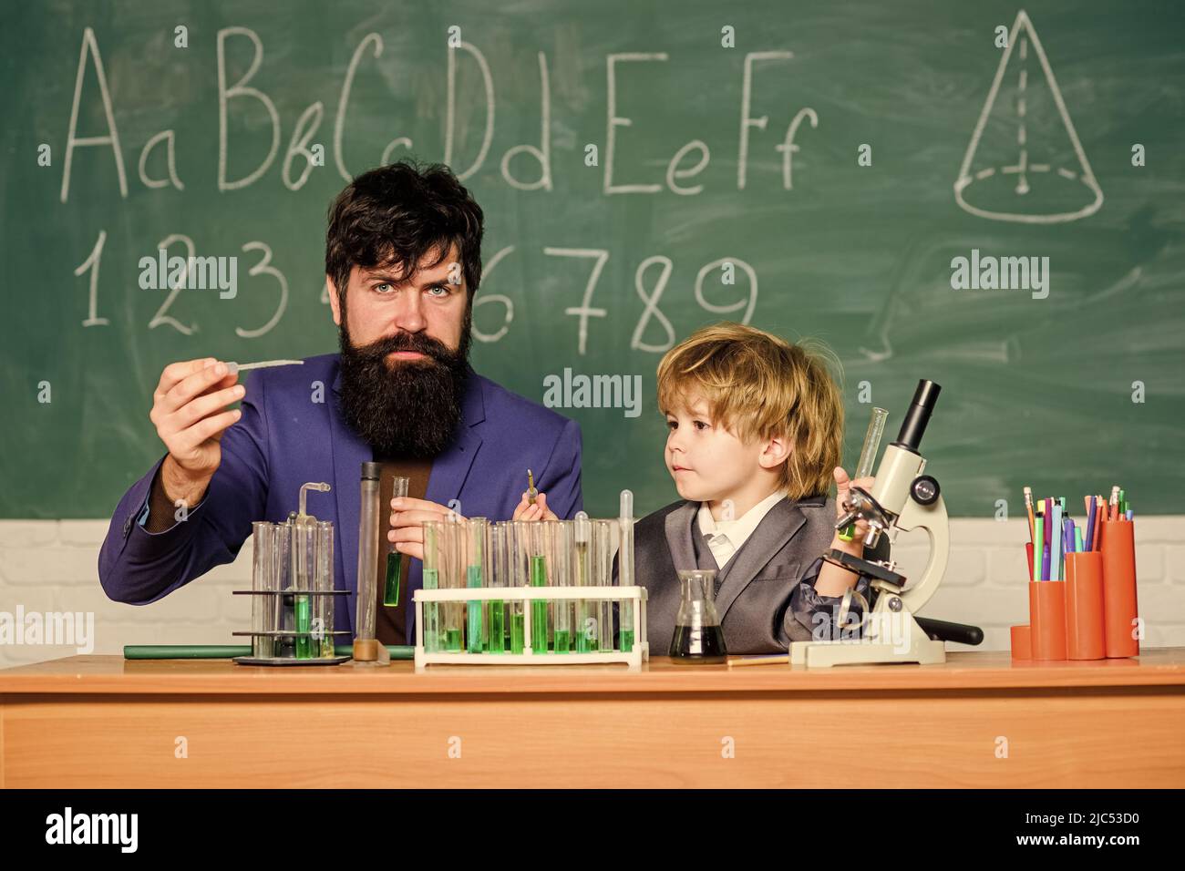 school kid scientist studying science. father and son at school. Little ...