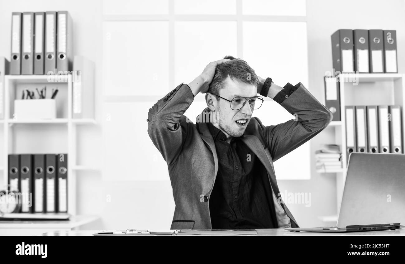 Man work online laptop computer in office, business failure concept ...