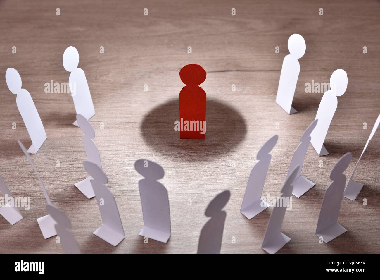 social discrimination concept with many little white paper men around a ...